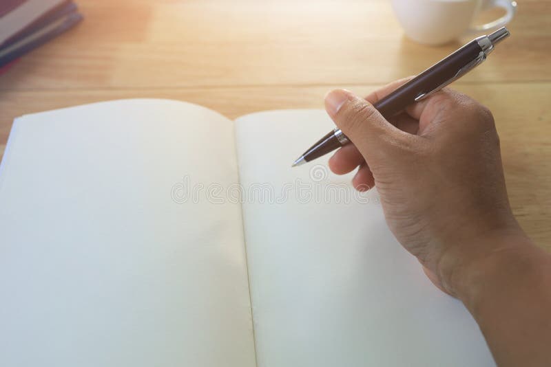 The Entrepreneur S Hand is Writing Down His Work in an Empty Diary ...