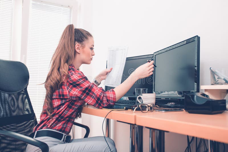 Entrepreneur Working Comparing Documents with a Computer Stock Image ...