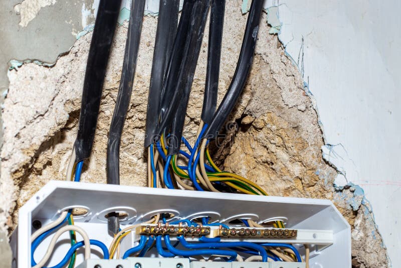 Entry of Wires into the Electrical Switchboard on the Wall. Conducting ...