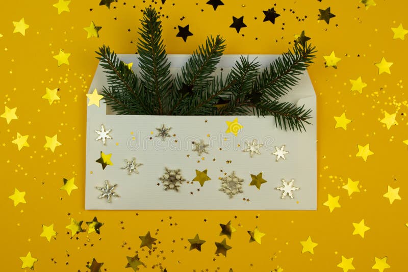 Envelope with Branch of Spruce on Yellow Surface Stock Photo - Image of ...