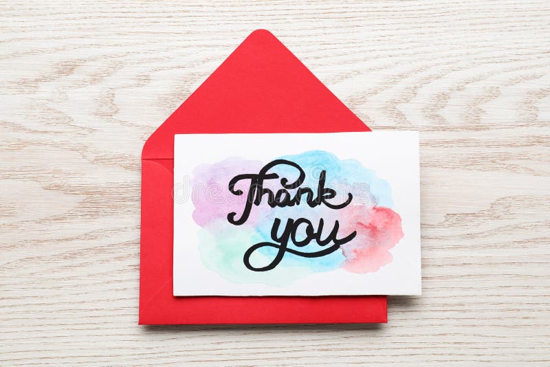 Envelope and Card with Phrase Thank You on Light Wooden Table, Top View ...