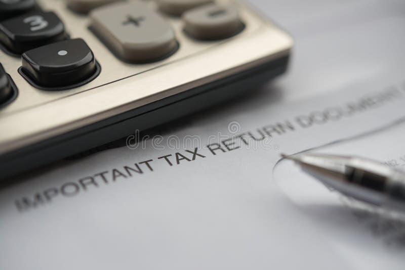 Envelope Printed with Important Tax Return and a Calculator and a Pen ...