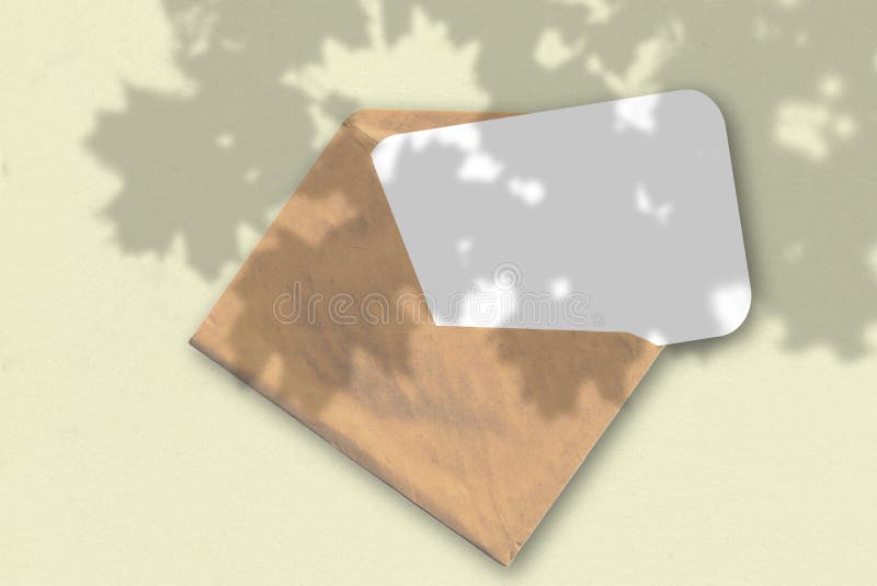 An Envelope with a Sheet of Textured White Paper on the Yellow ...