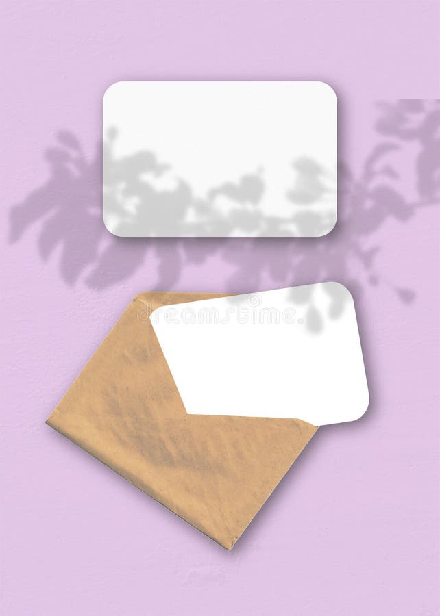 An Envelope with Two Sheets of Textured White Paper on the Pink ...