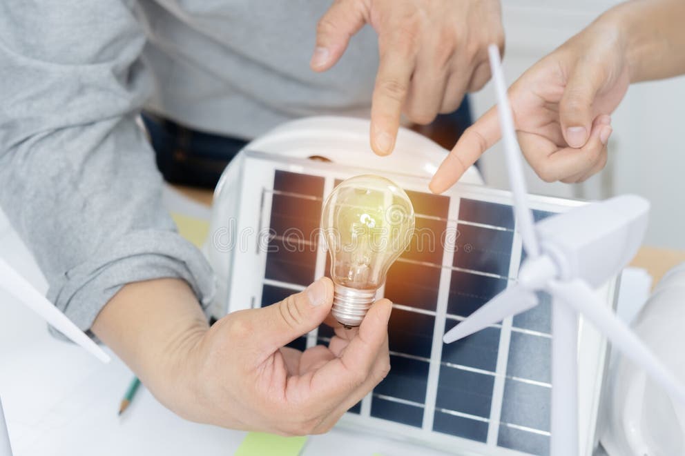 Environmental Engineer Holding and Pointing Light Bulb in Modern Office ...
