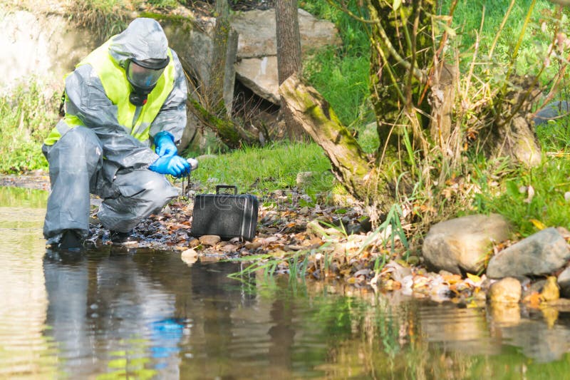 Environmental Pollution Scientist in Protective Suit Adjusts Rubber ...