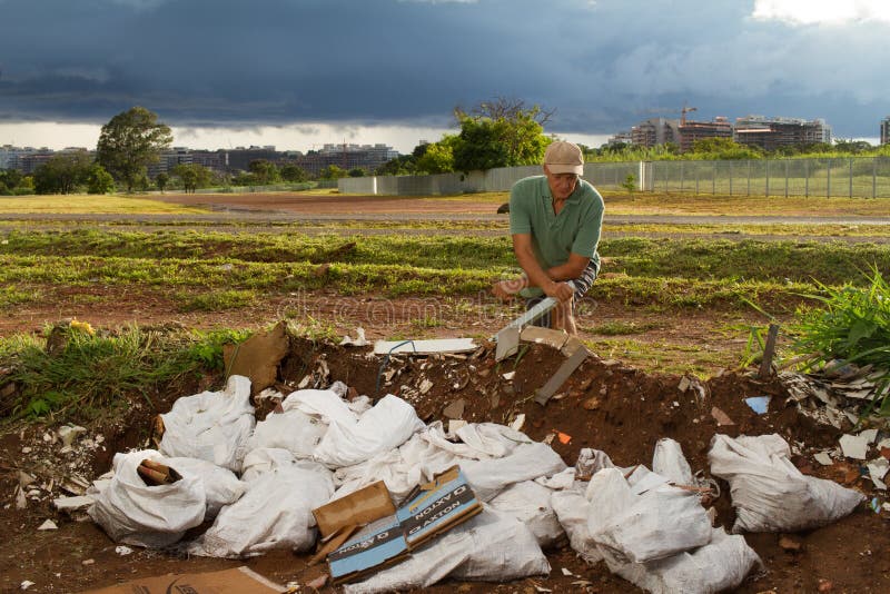 Environmental Worker Looking through Some Discarded Trash Stock Photo ...