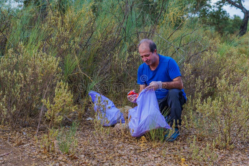 Environmentalist Man Picking Up Garbage from the Field Stock Image ...
