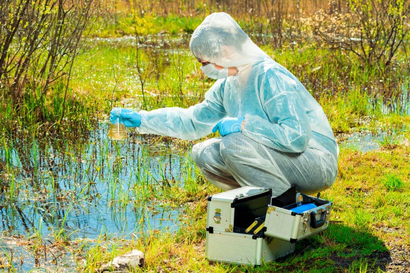 Environmentalist on the Shore of a Forest Lake Takes Water Samples ...