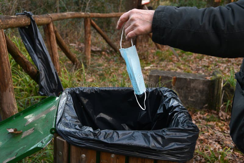 Environmentally Friendly Person Throws a Protective Mask in the Garbage ...