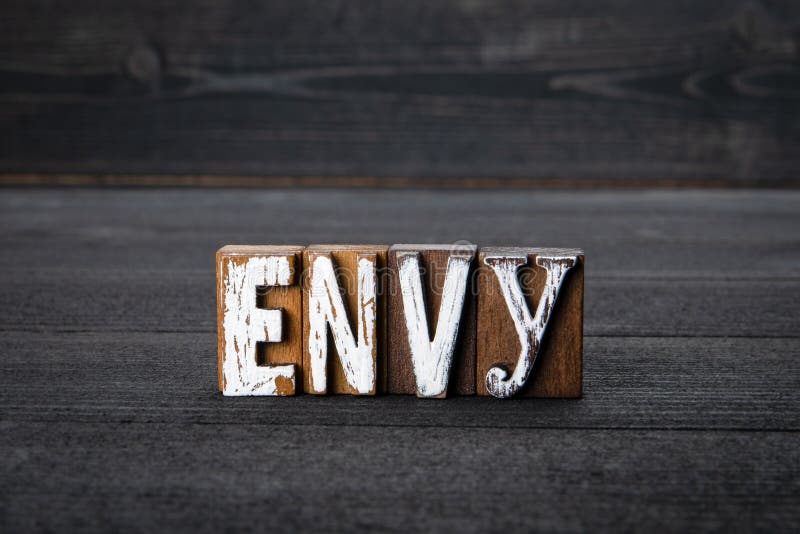 ENVY. Text from Alphabet Blocks on a Dark Wooden Background Stock Photo ...