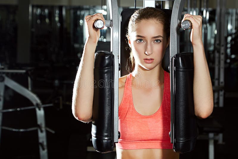 Epic Gym Session in Progress. a Young Woman Using an Exercise Machine ...
