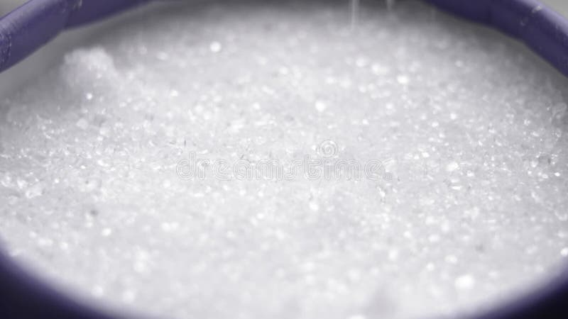 Epsom Salt Crystals Falling into Blue Cardboard Container in Slow ...