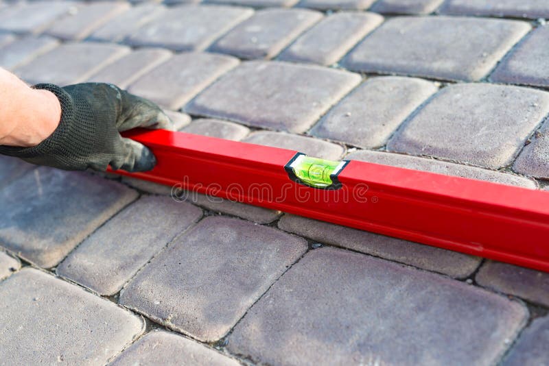 Equality check using level stock image. Image of paving - 133720065