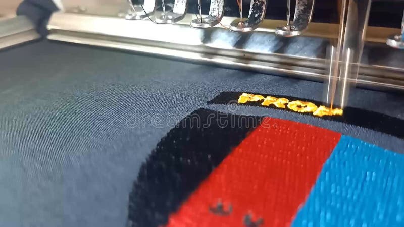 The Process of Embroidering Yellow Thread in Making a Logo Using a ...