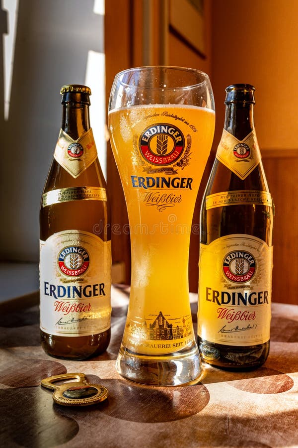 Erdinger Beer is Poured in a Branded Beer Glass and Two Bottles ...