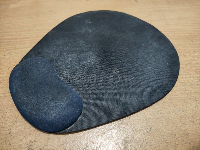 Black Ergonomic Mouse Pad with Wrist Rest on Wooden Surface Stock Image ...