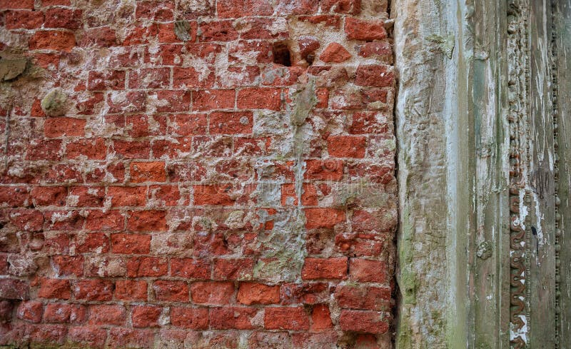 Eroded Brick Wall with Patches of Moss and Decay. Cracked and Weathered ...