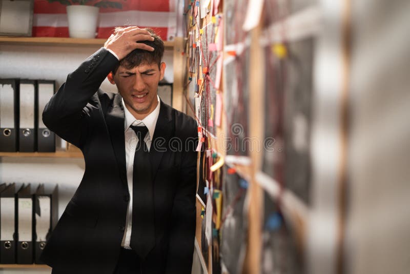 Error. Portrait of Sad Stressed Detective Looking on Evidence Board ...
