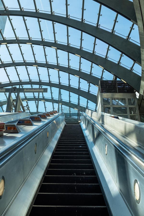 Escalator Ascending Under a Curved Glass Ceiling. Canary Wharf, UK ...