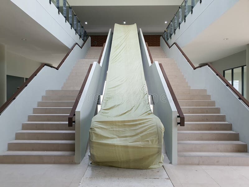 An Escalator Covered with a Tarp, Flanked by Two Staircases in a ...