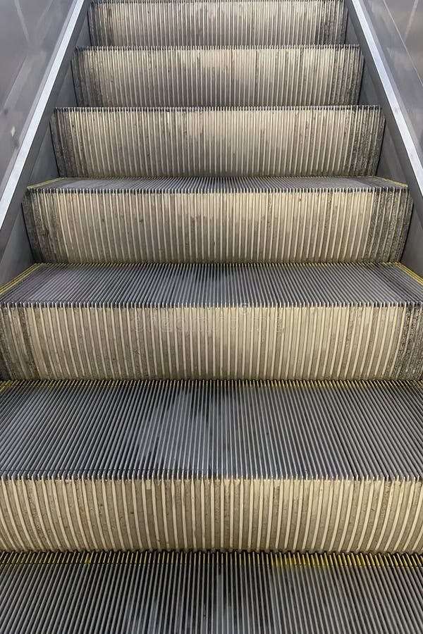 An Escalator is a Moving Staircase Which Carries People between Floors ...