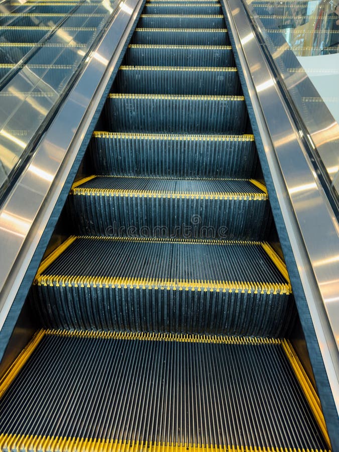 The Escalator is Very Long and Has Yellow Stripes Stock Image - Image ...