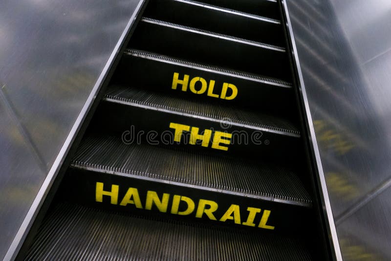 Escalator with Yellow Hold the Handrail Warning Stock Image - Image of ...