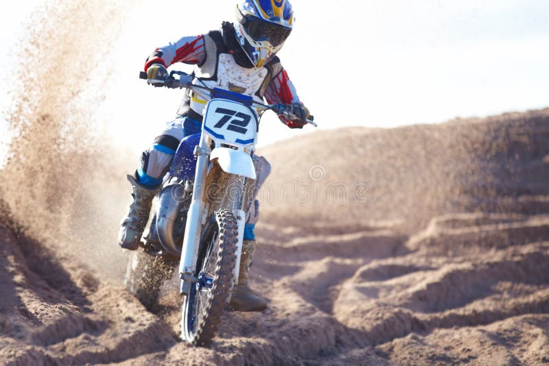 Escaping a Sea of Sand. a Motocross Rider Riding Towards the Camera ... Escaping a Sea of Sand. a Motocross Rider Riding Towards the Camera ...