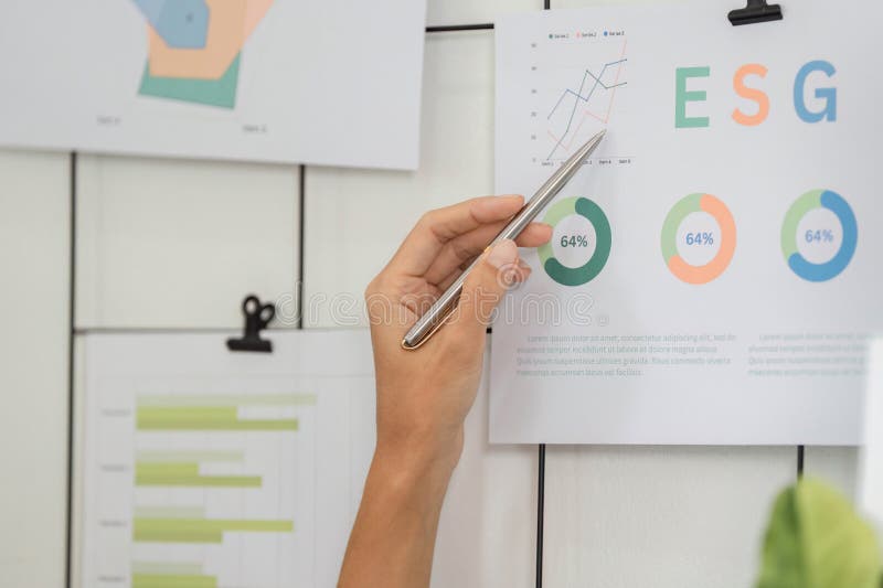 ESG Analysis Featuring Hand Pointing at Sustainable Metrics on Wall ...