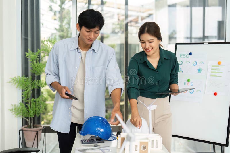 ESG Principles in Architecture. Young Professionals Collaborating on Design Model. Stock Photo ...