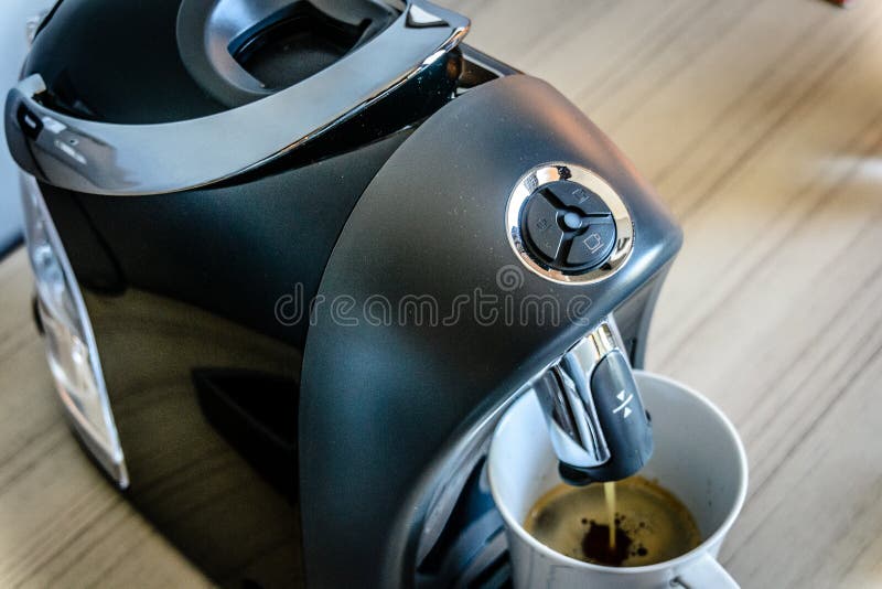 Espresso Coffee Maker Machine Making and Flowing Out Espresso into a ...