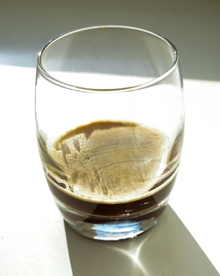 Espresso Remnants in Sunlit Glass Cup. Stock Image - Image of light ...