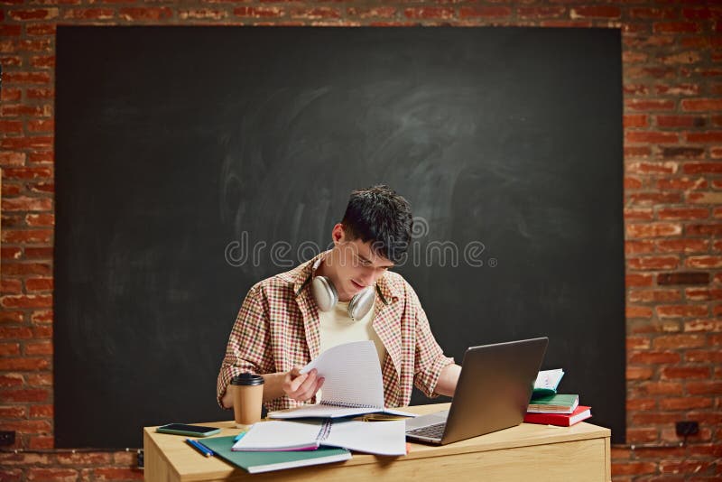 The Essence of Learning. Deeply Focused Young Man, Studying in ...
