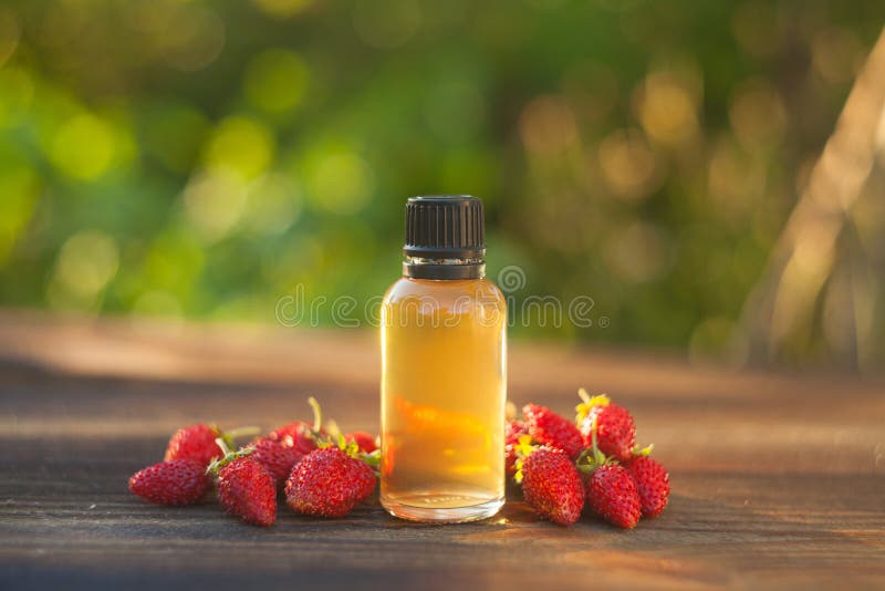 Essence of Wild Strawberry on Table in Beautiful Glass Jar Stock Photo ...