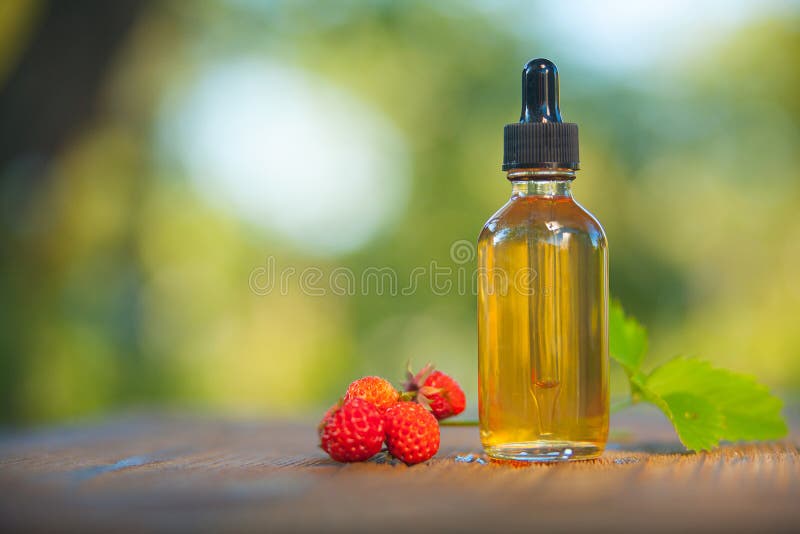 Essence of Wild Strawberry on Table in Beautiful Glass Jar Stock Image ...