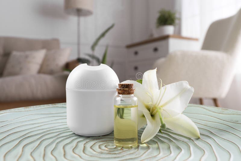 Essential Oil Diffuser, Cosmetic Product and Lily Flower on Table at ...