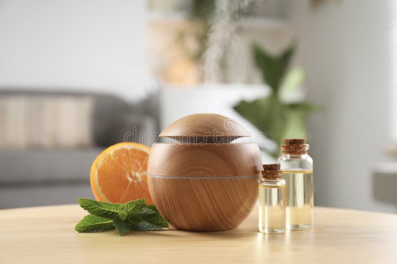 Essential Oil Diffuser, Cosmetic Products, Mint and Orange on Wooden ...