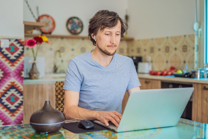 Essential Oil Diffuser on the Table Steaming while Man Using Laptop ...