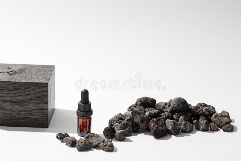 Essential Oil in Glass Bottle on Solid Oak Black Cube for Aromatherapy ...