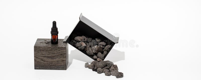 Essential Oil in Glass Bottle on Solid Oak Black Cube for Aromatherapy ...