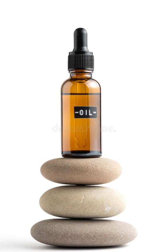 Essential Oil in Glass Bottle on Stack of Pebbles Stock Image - Image ...