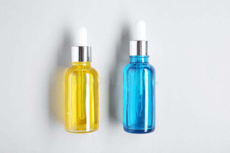 Essential Oils in Bottles on Light Background, Top View Stock Photo ...