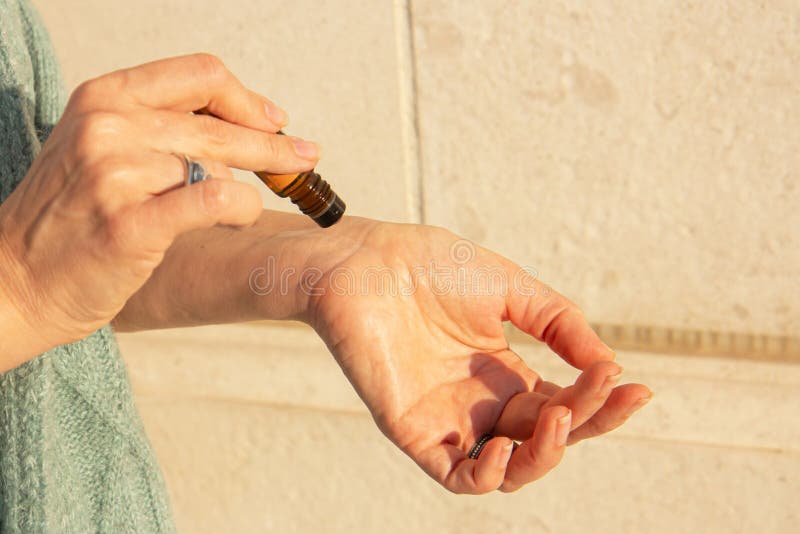 Essential Oils Roller Bottle in the Hand of a Woman Stock Photo - Image ...