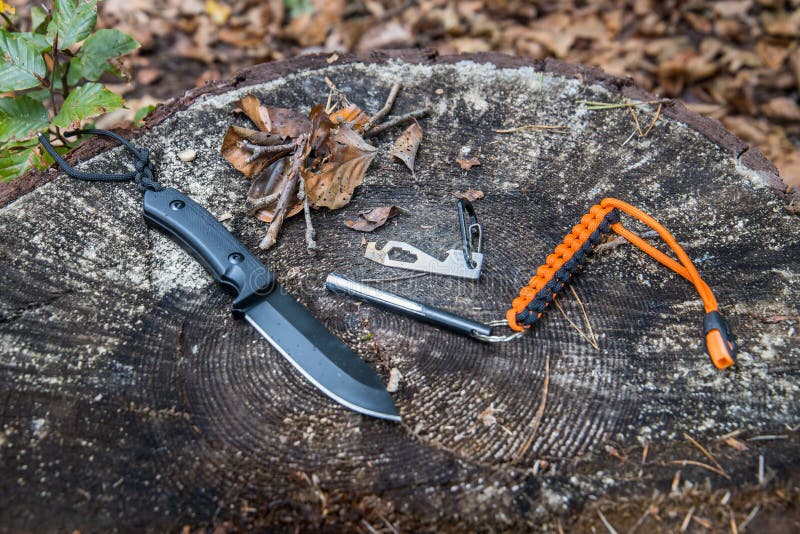 Essential Tactical Bushcraft Tools on a Tree Stump Stock Photo - Image ...