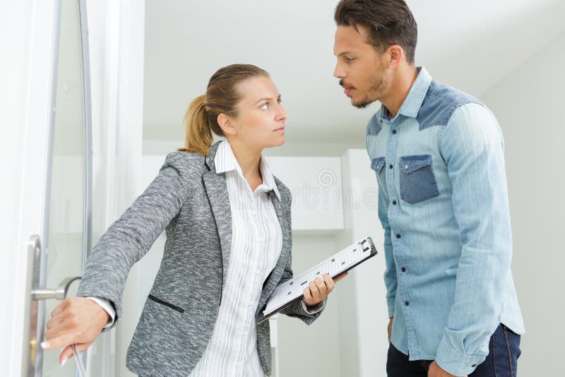 Estate Agent Opening Door for Client Diring Visit Stock Photo - Image ...