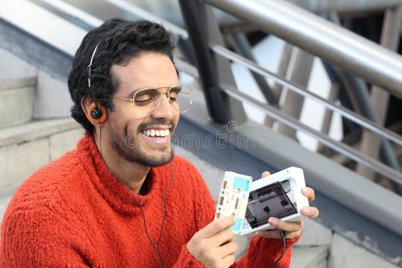 Ethnic guy using a walkman stock photo. Image of cable - 164901934