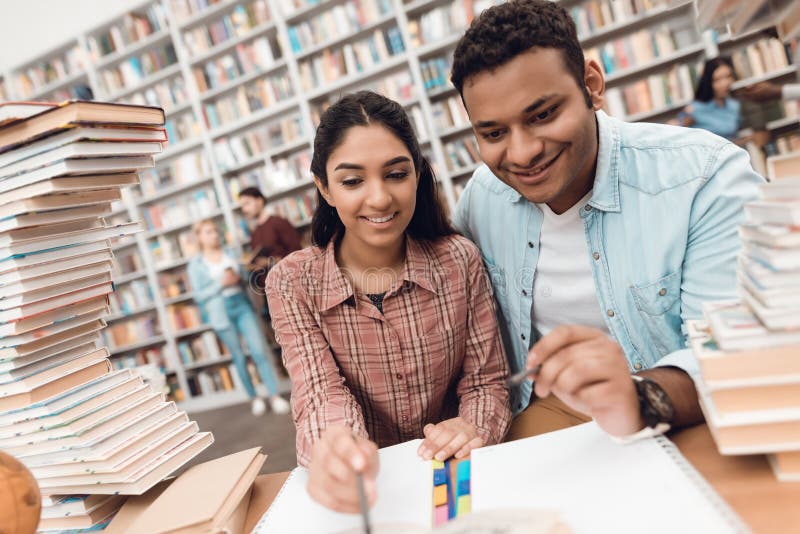 Ethnic Indian Mixed Race Girl and Guy Surrounded by Books in Library ...