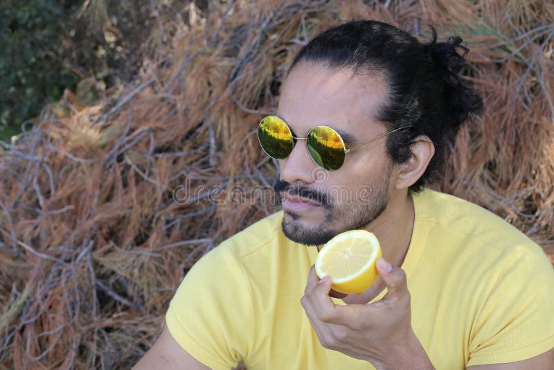 Ethnic Man in Yellow Holding Bright Lemons Stock Image - Image of model ...