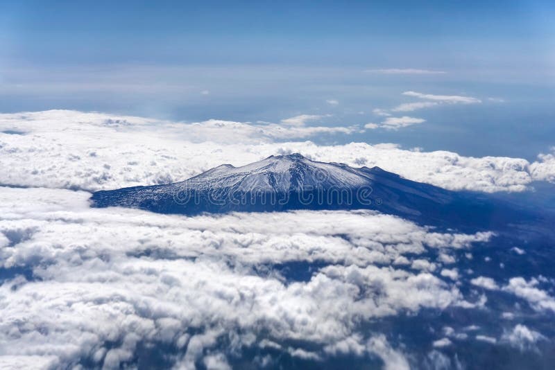 Etna Volcano Covered in Snow. View from the Plane through Clouds Stock ...